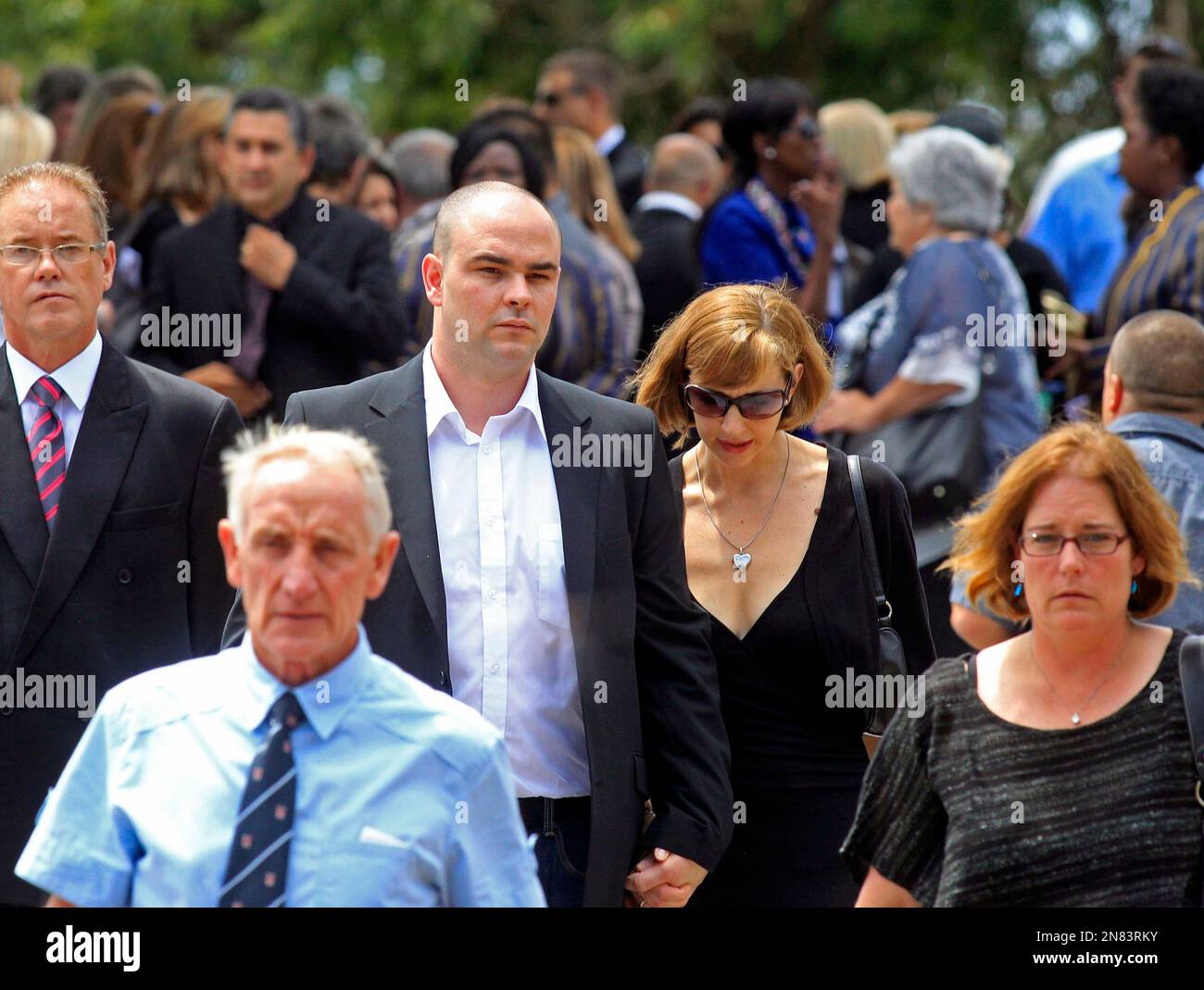 Adam Steenkamp, centre left, the brother of Reeva Steenkamp, walks with ...