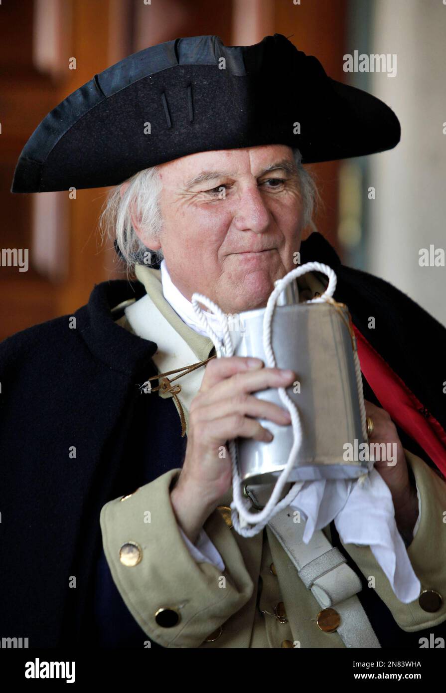 George Washington presidential presenter C. Roger Cooper takes a drink ...
