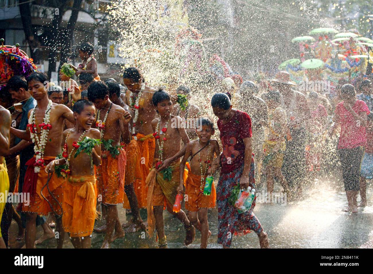 Myanmar Hindu devotees spray holy water on to devotees during a ...