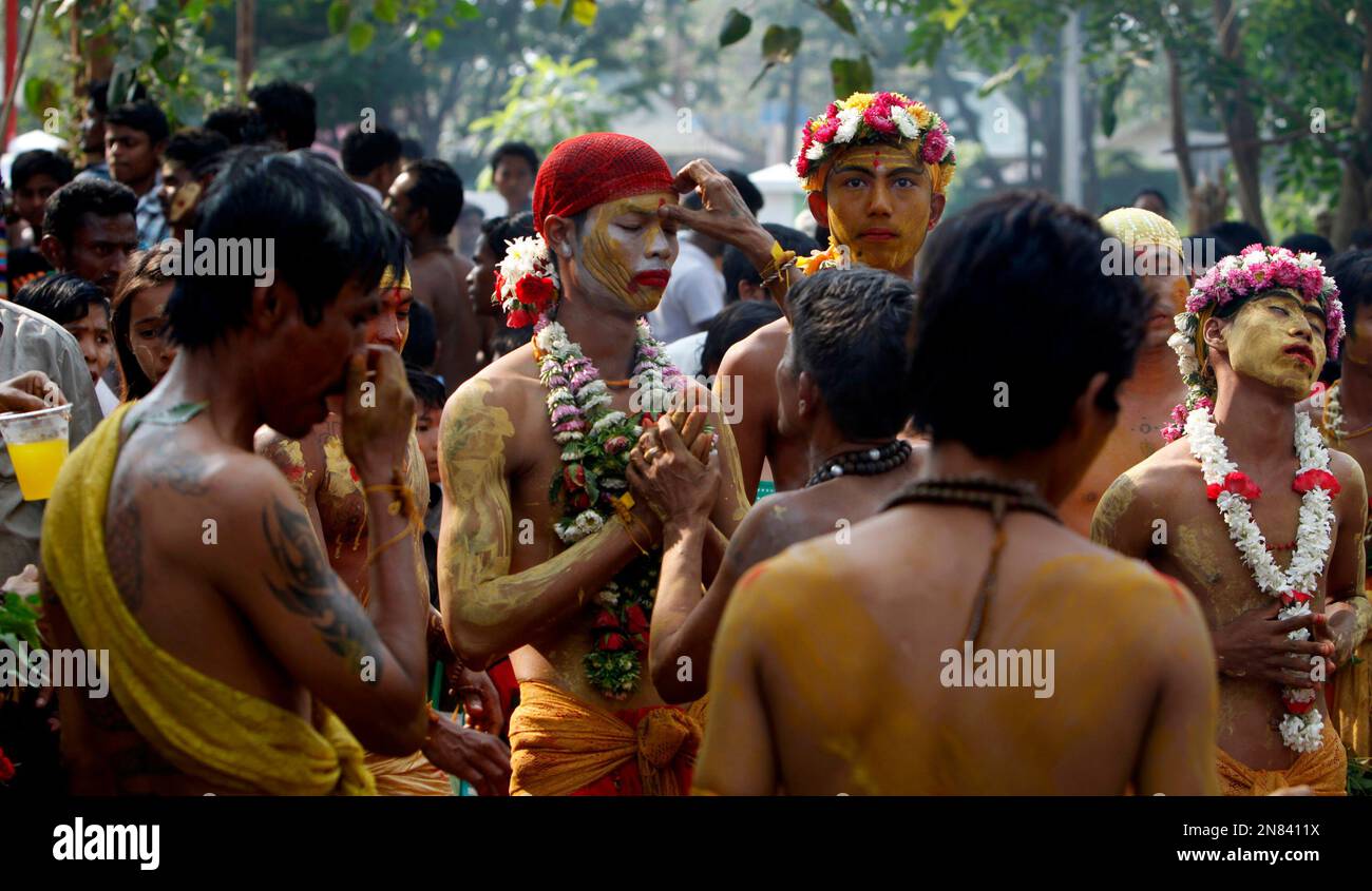 Myanmar Hindu devotees pray as they wait to walk on burning embers ...