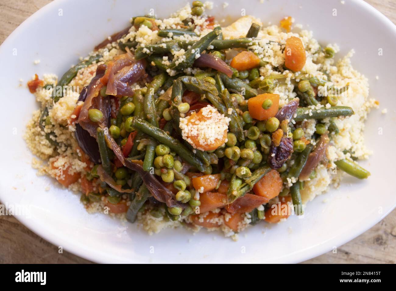 traditional vegetarian couscous with steamed mixed vegetables and herbs ...