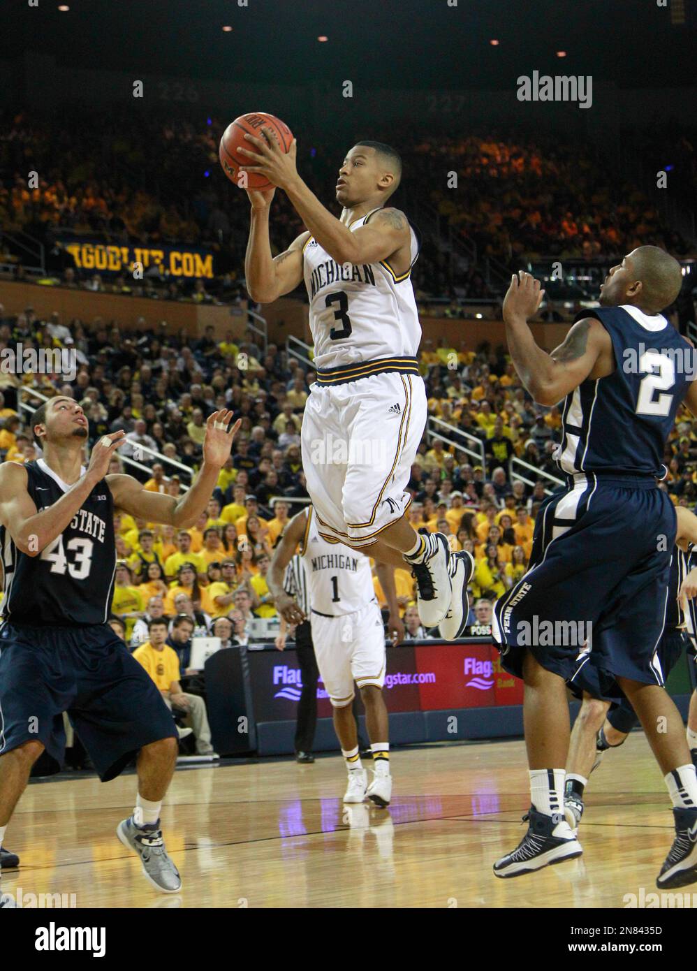 Michigan guard Trey Burke (3) goes for two points between Penn State ...