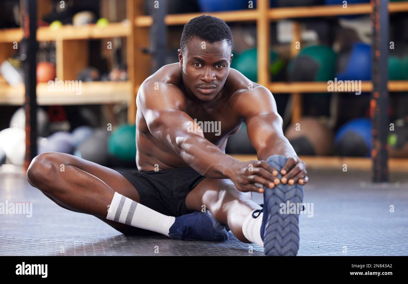 Stretching, training and portrait of black man in gym for sports ...
