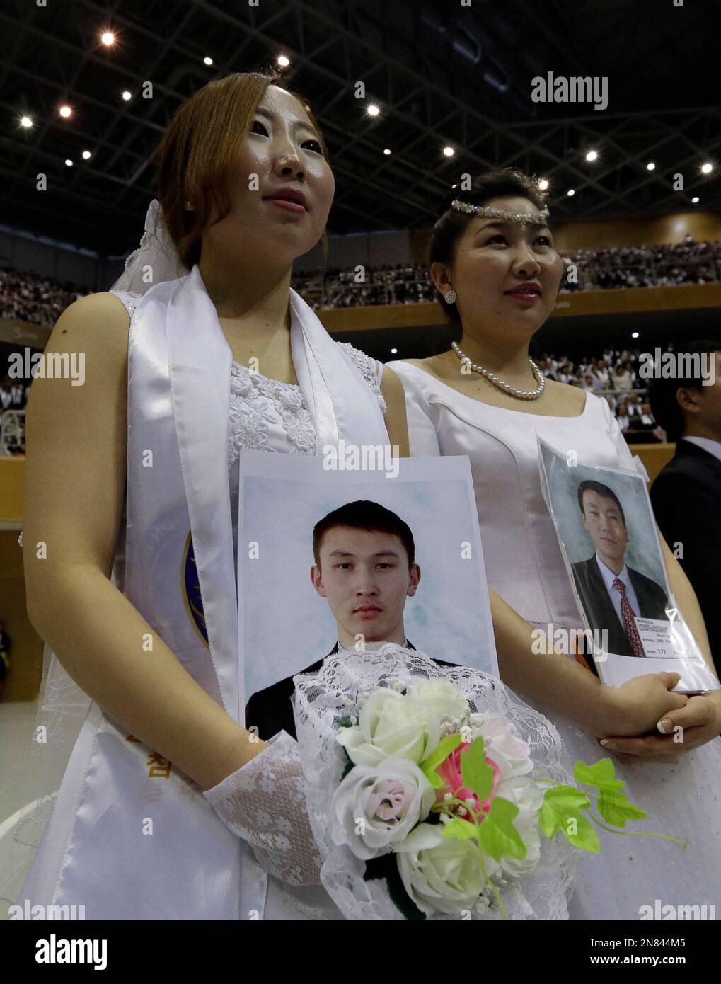 Mongolian bride Enkhzul Baatarchuluun, left, holds the picture of her ...