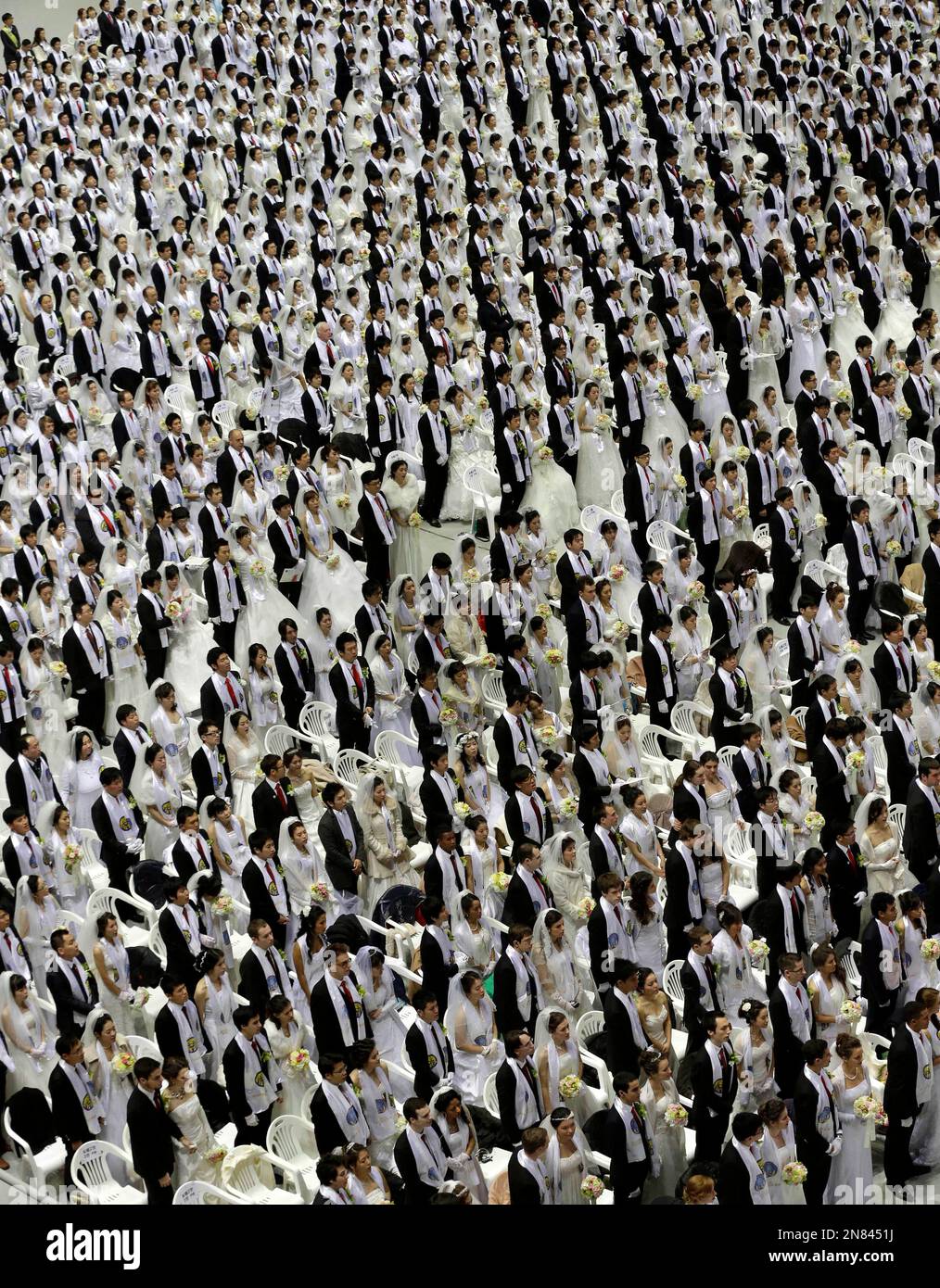Couples from around the world participate in a mass wedding ceremony at ...