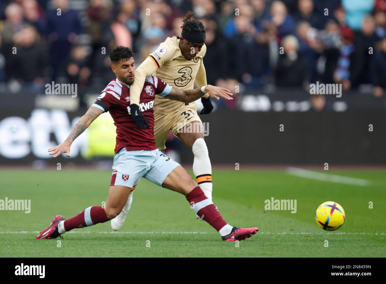 West Ham's Emerson Palmieri, centre, challenges for the ball with ...