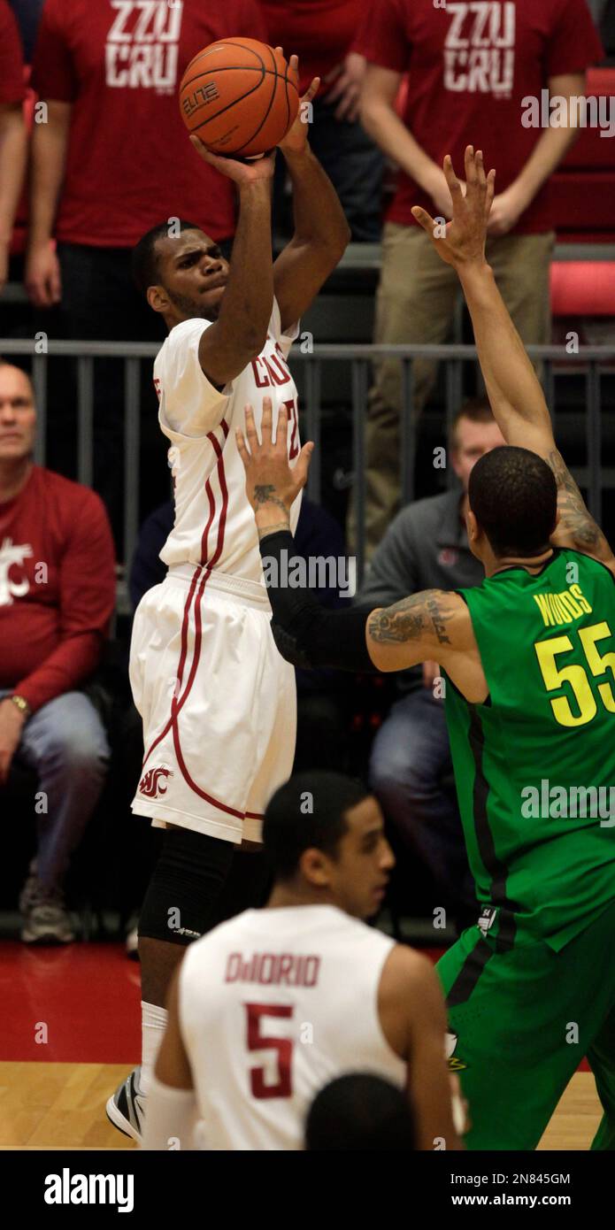 Washington State guard Royce Woolridge, left, scores a three-point ...