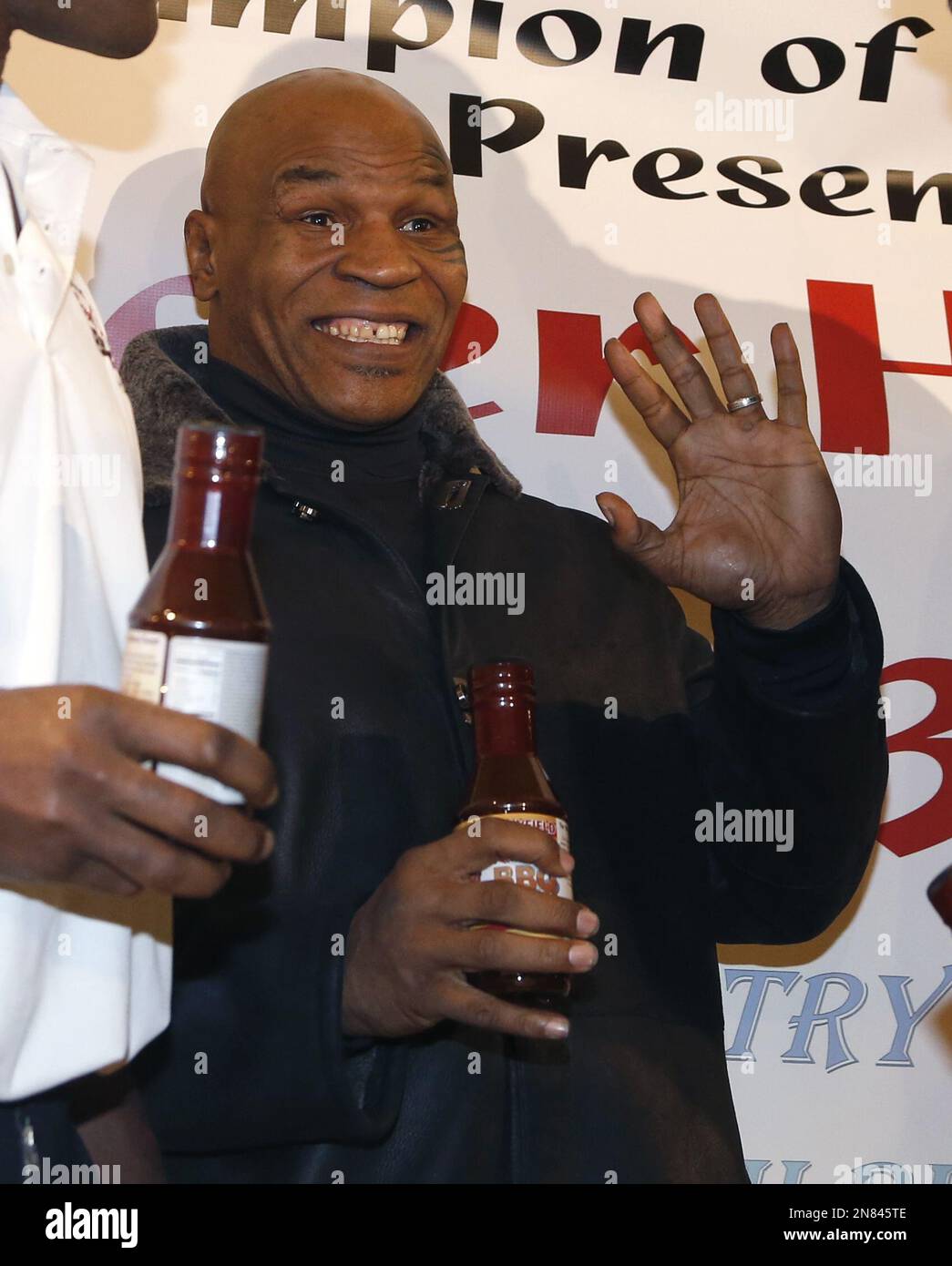 Former heavyweight champion Mike Tyson smiles and waves to fans during ...