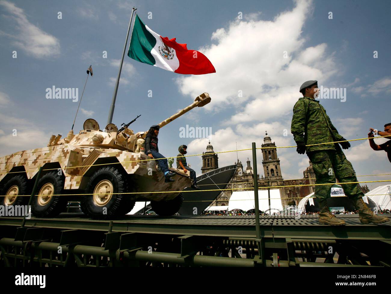Children sit on an armored vehicle on display ahead of Mexico's Armed ...