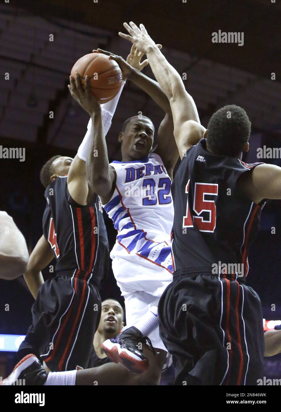 DePaul guard Charles McKinney (32) shoots between the Rutgers defense ...