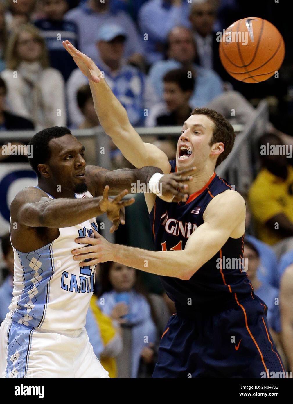 North Carolina's P.J. Hairston passes as Virginia's Evan Nolte defends ...