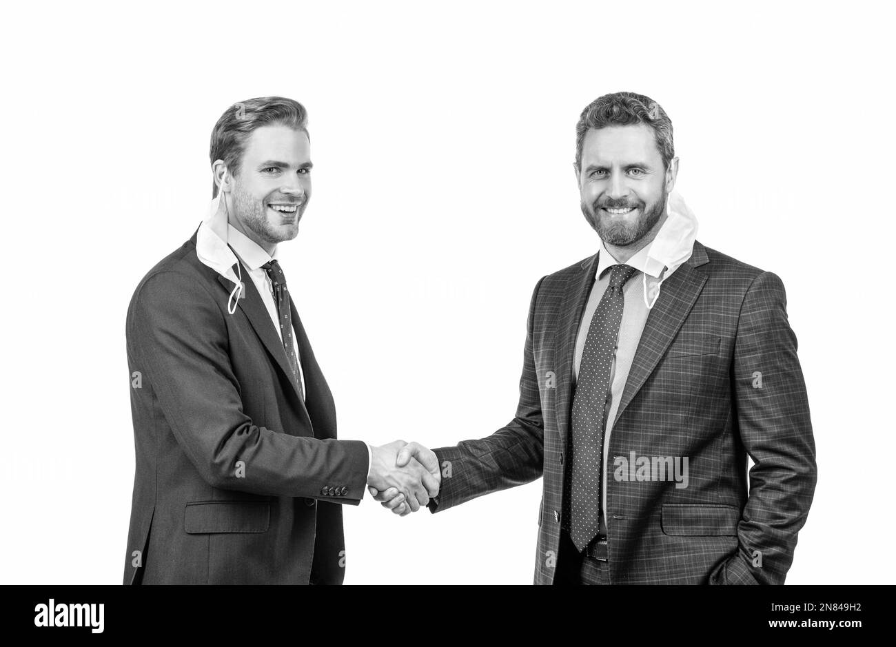 successful negotiations. welcome. two men in mask shaking hands ...