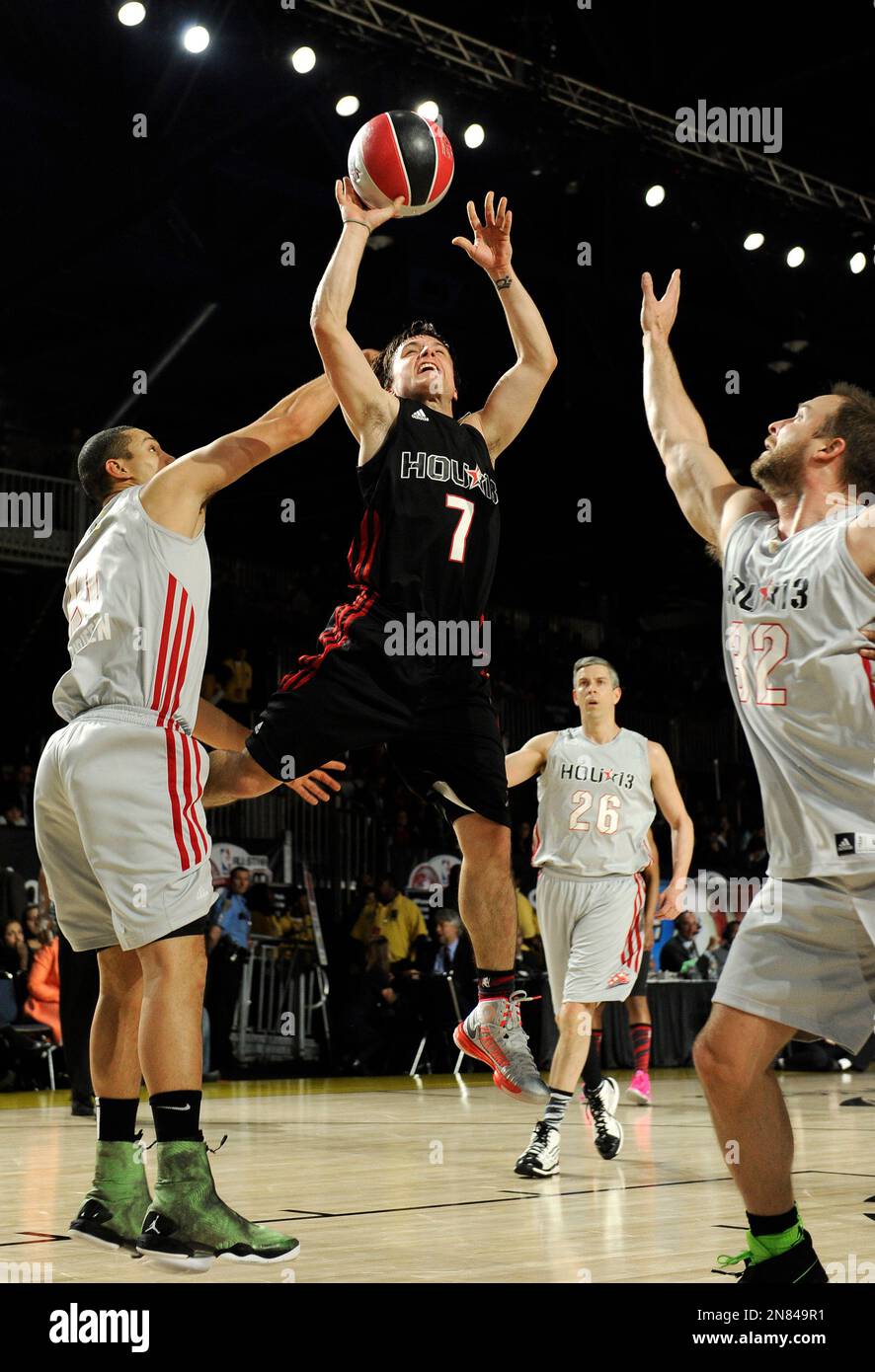 Actor Josh Hutcherson (7) shoots between Common, left, and Ryen Russell ...