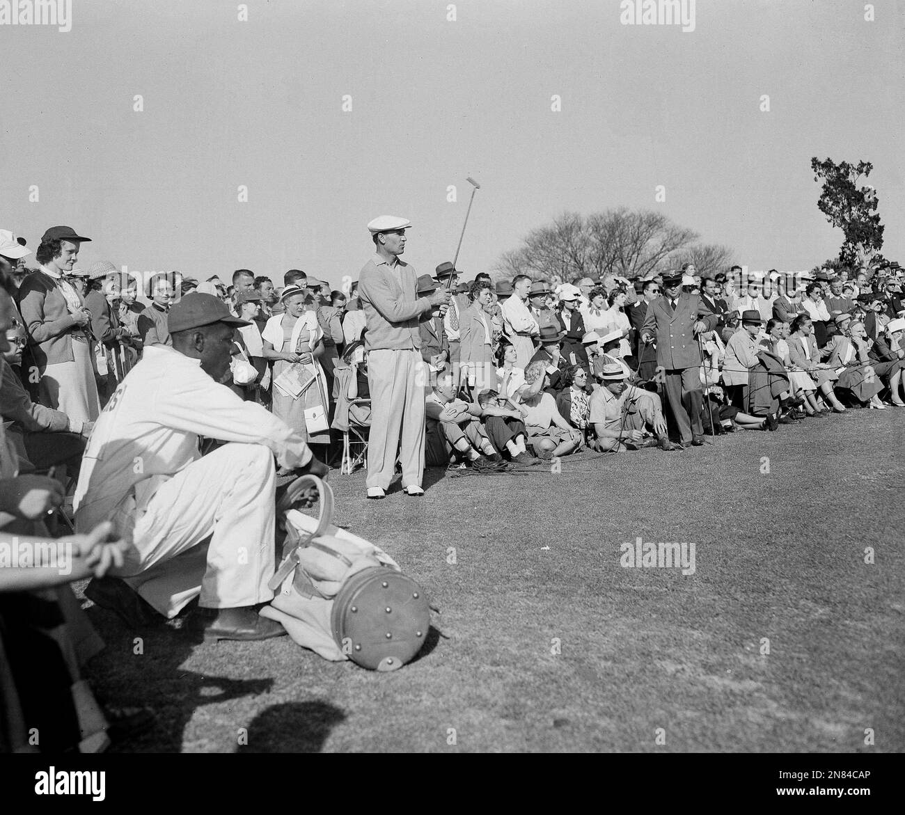 Pro golfer Ben Hogan swings his putter as he watches his ball barely ...