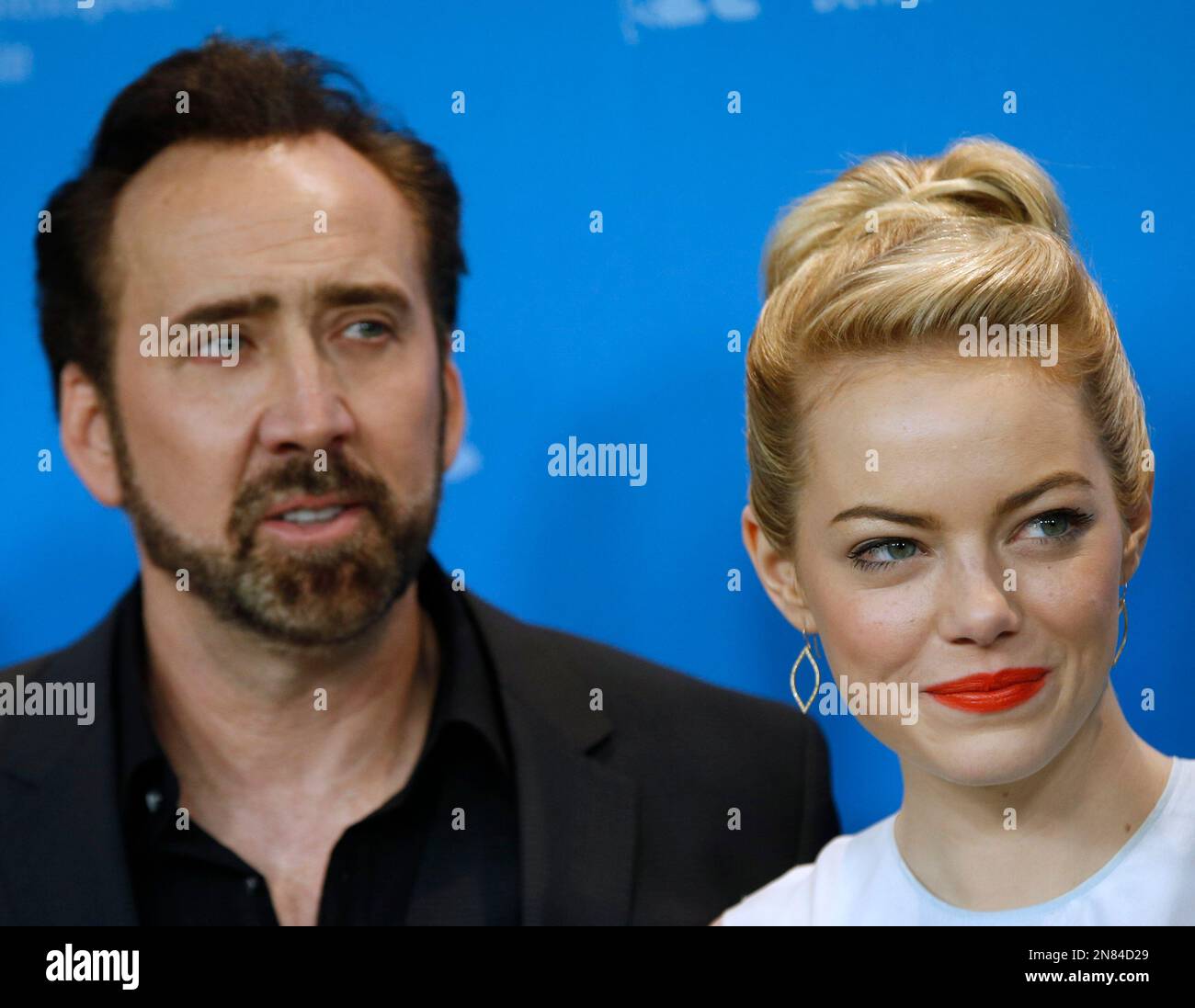 Actors Nicholas Cage, left, and Emma Stone pose for photographers at ...