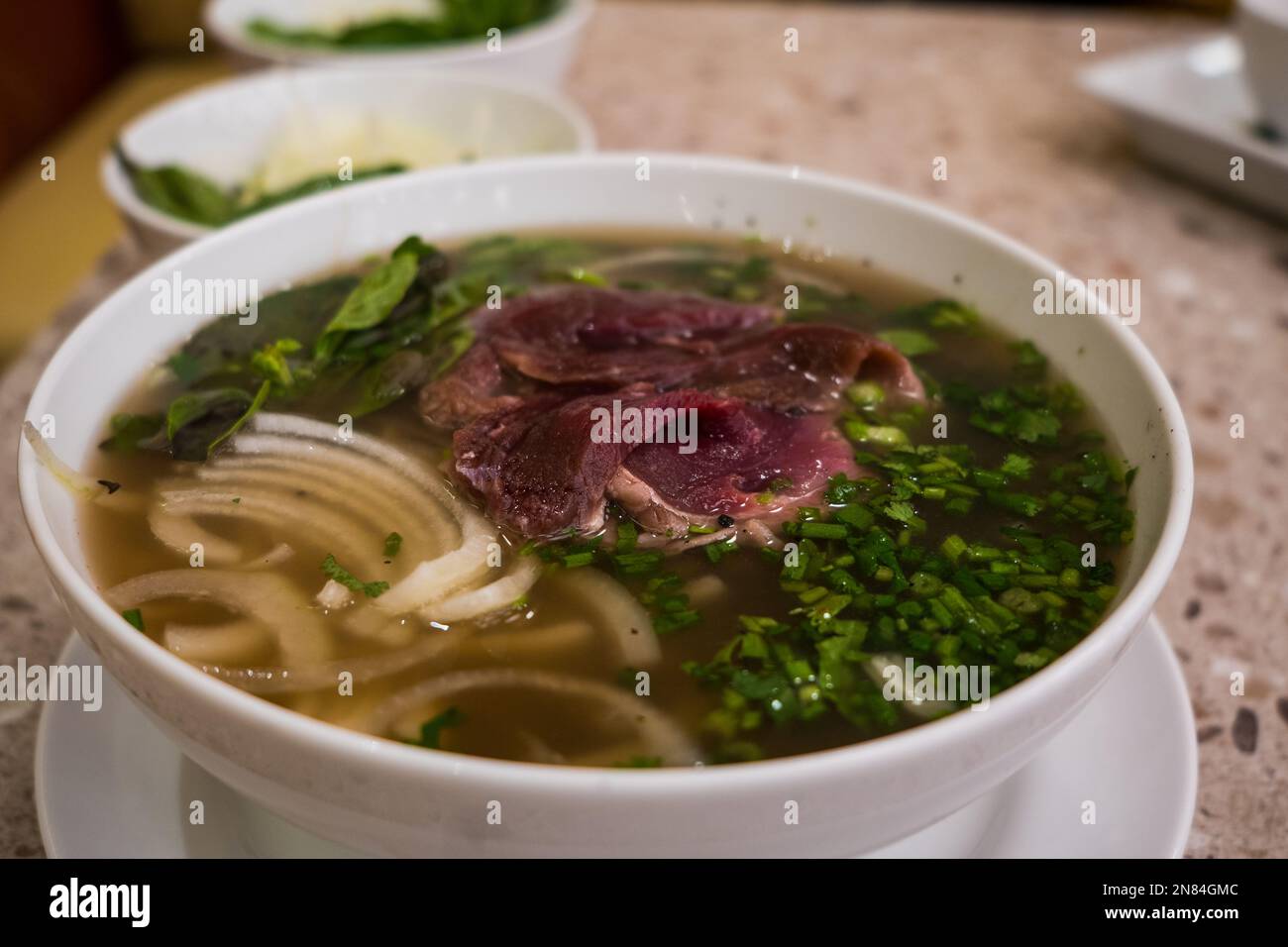 Close up of Vietnamese pho soup with beef, meatball, fresh vegetable ...