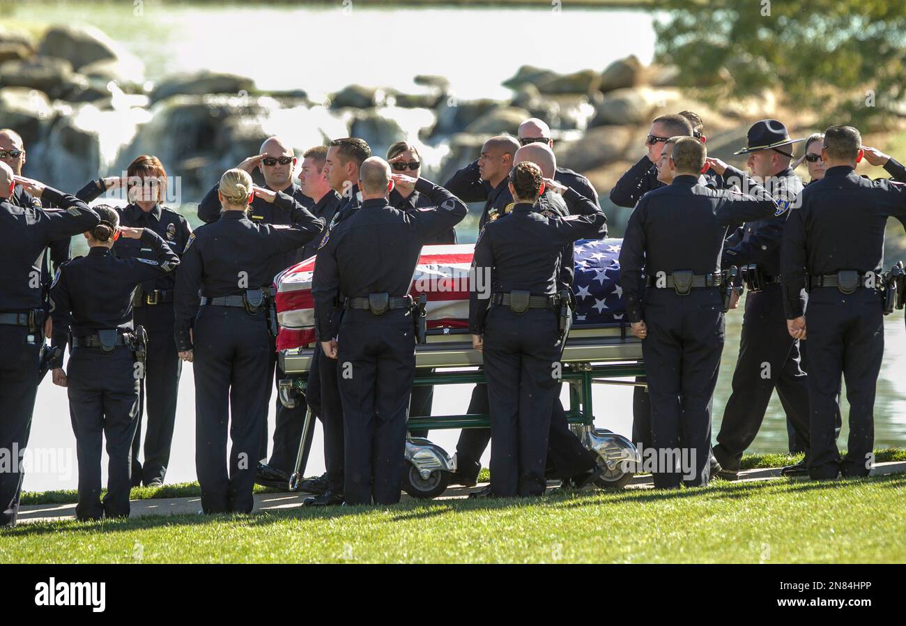 Riverside Police officers salute the casket of fellow Riverside Police ...