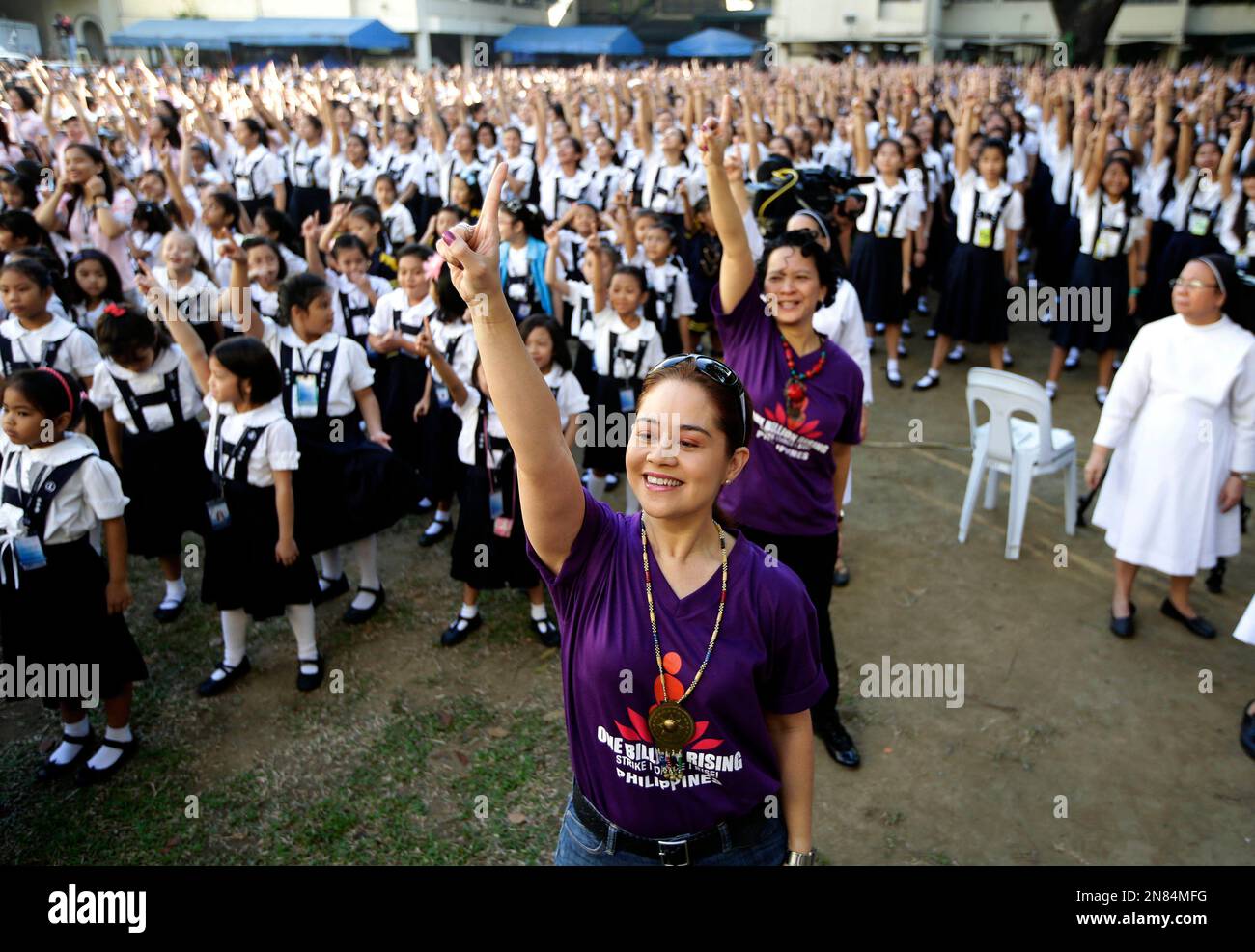 Filipino theater artist Monique Wilson flashes the No.1 sign with ...