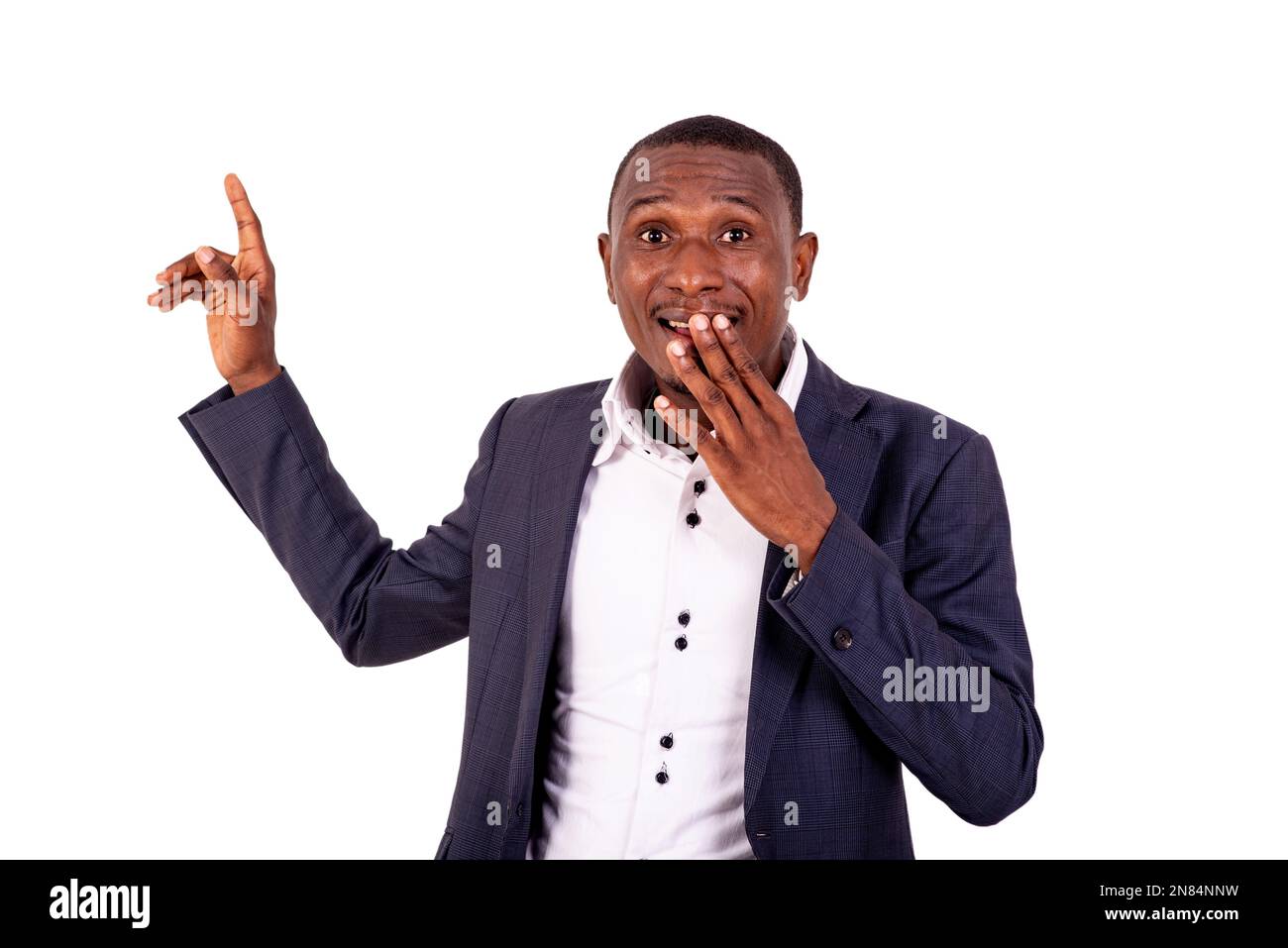 young business man with hand over mouth raising finger while smiling at ...