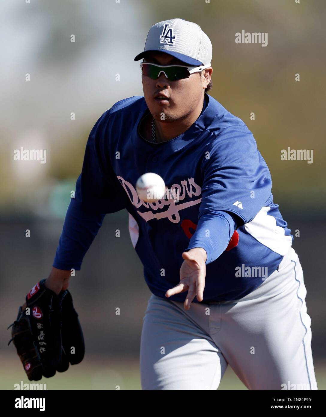 Los Angeles Dodgers pitcher Hyun-Jin Ryu, of South Korea, tosses a ball ...