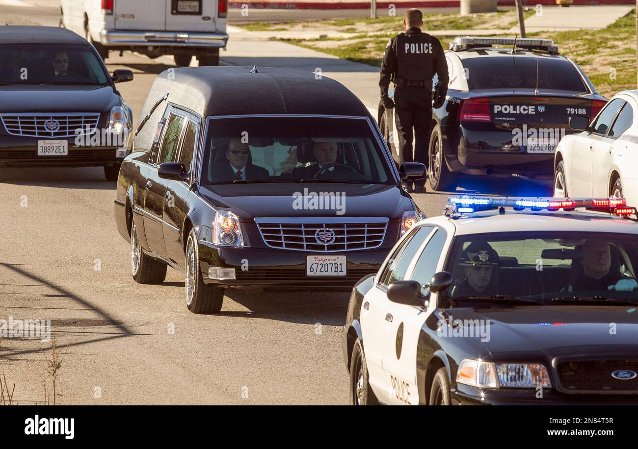 A funeral hearse carrying the casket of Riverside Officer Michael Crain ...