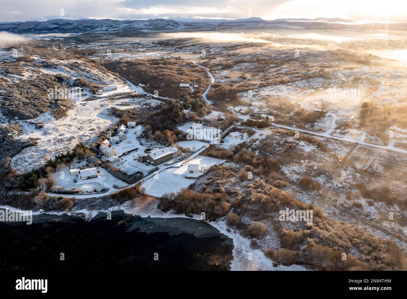 Aerial view of snow covered Lake House by Portnoo in County Donegal ...