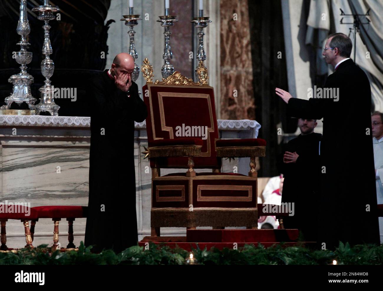 Master of ceremonies stand near Pope Benedict XVI's chair prior to the ...
