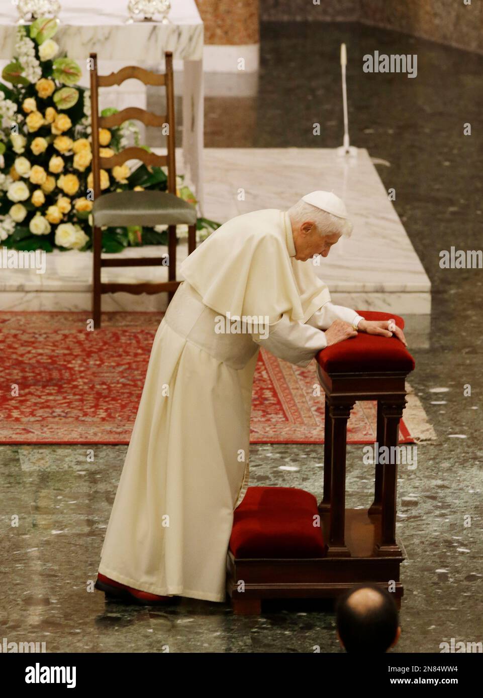 Pope Benedict XVI gets up after praying at the Roman seminary, in Rome ...