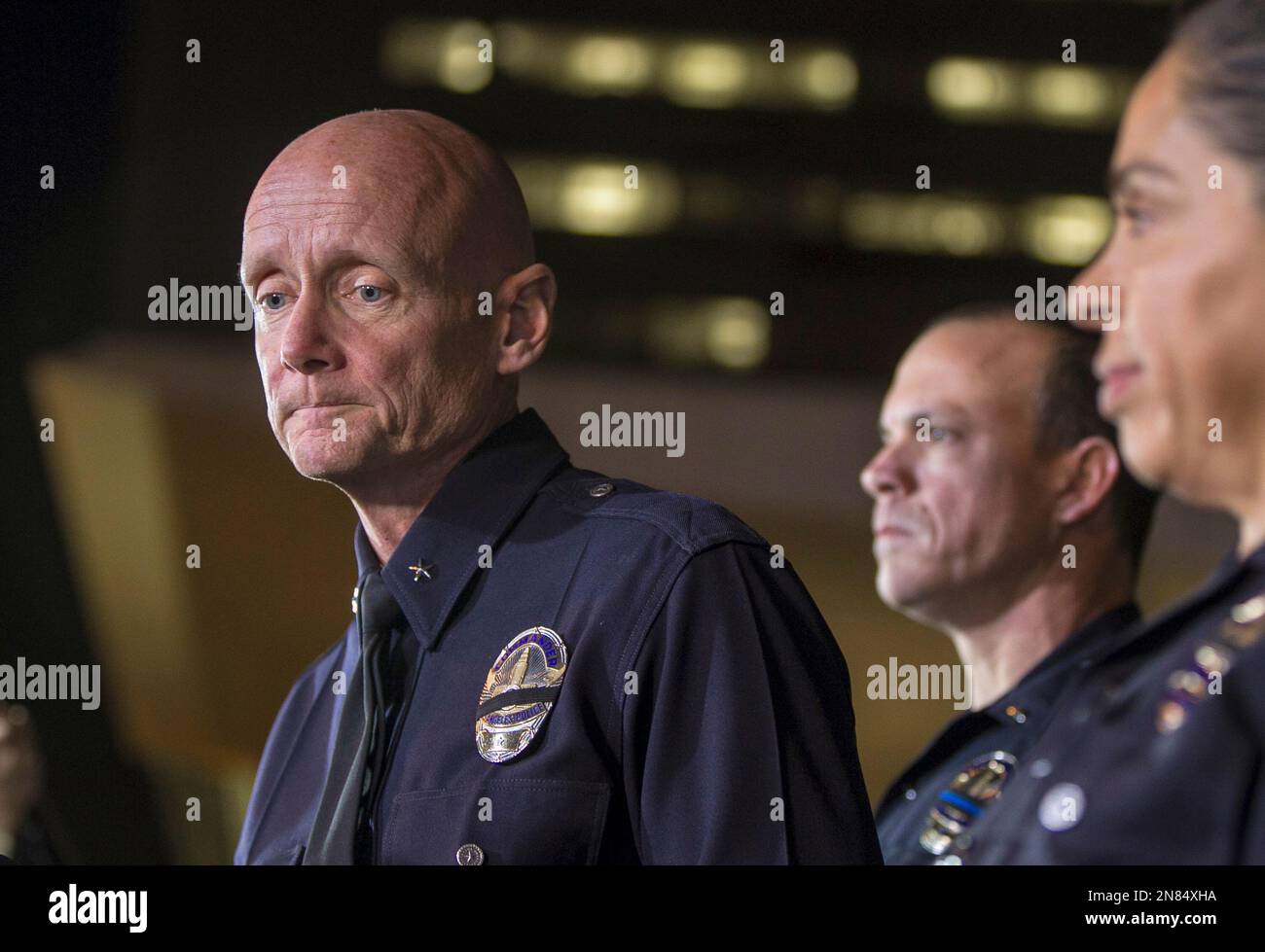 Los Angeles Police Commander Andrew Smith, left, expresses condolences ...
