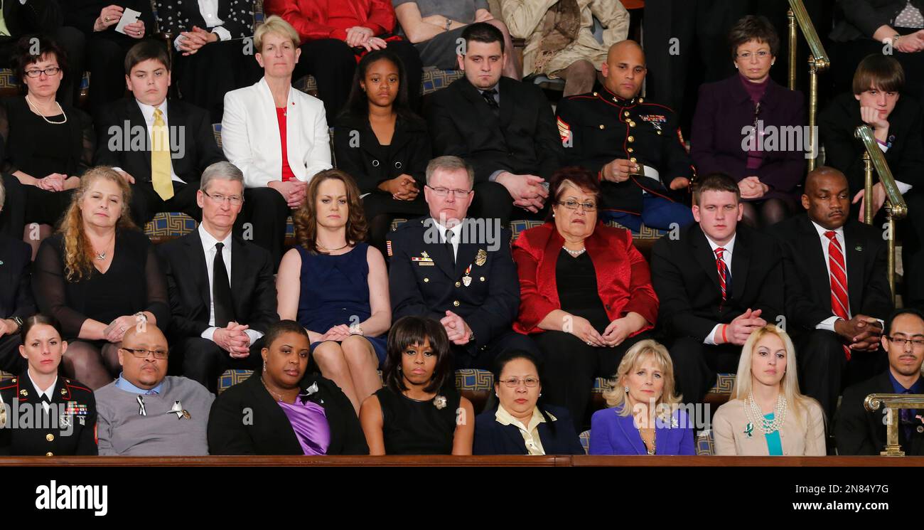 First lady Michelle Obama, front row, center, and other, listen as ...