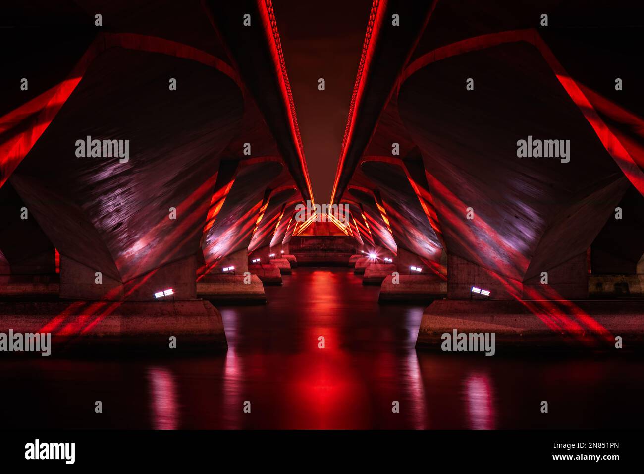 Red lights under a modern concrete bridge Stock Photo - Alamy