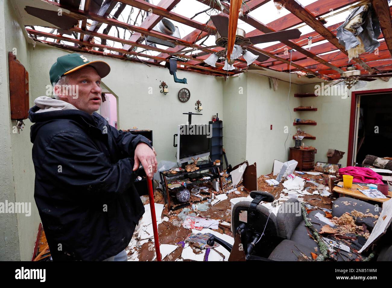 Brian Bernard looks around what remains of his living room at his Petal ...