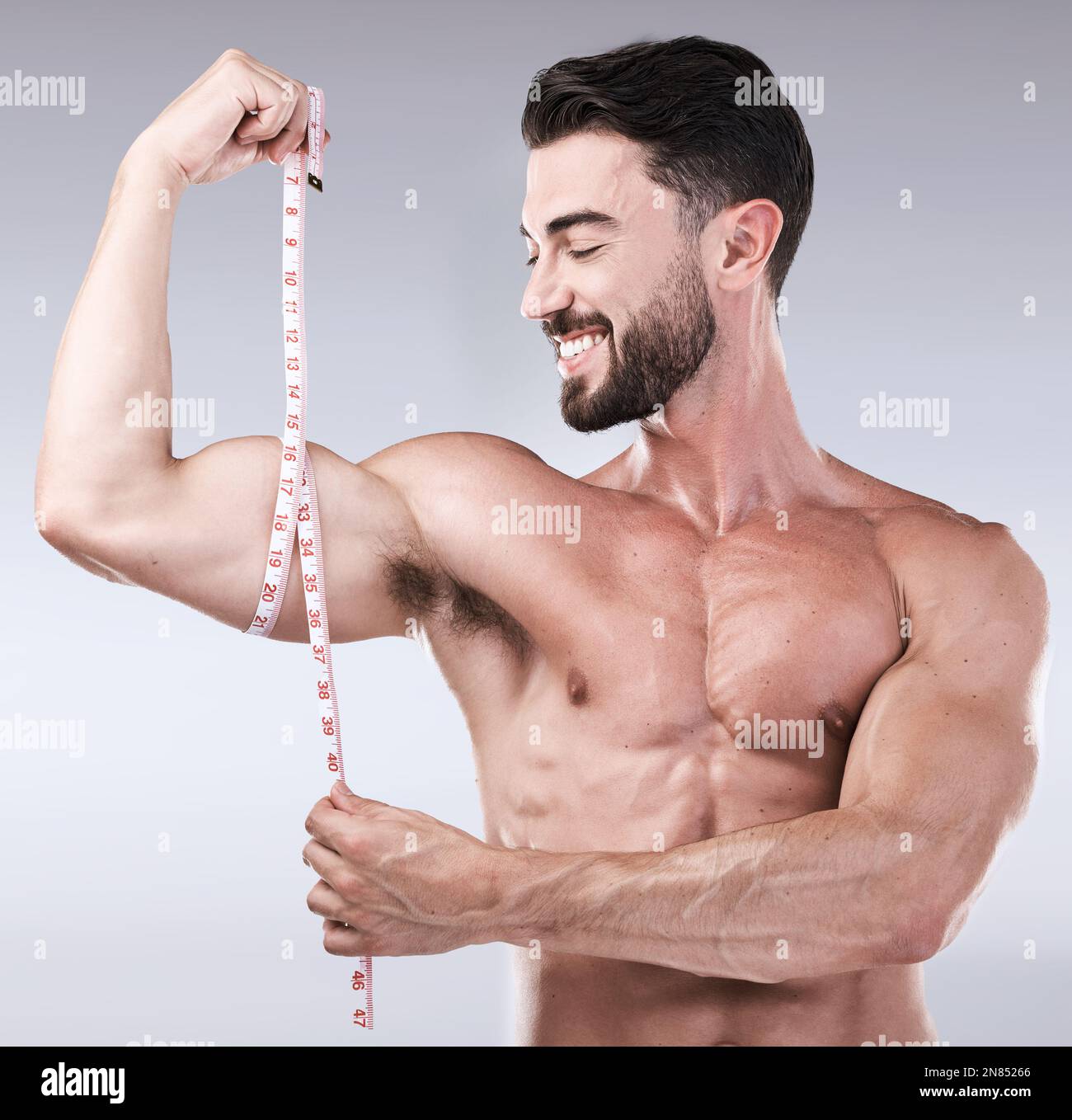 Fitness, goals or strong man with tape measure for biceps after body ...