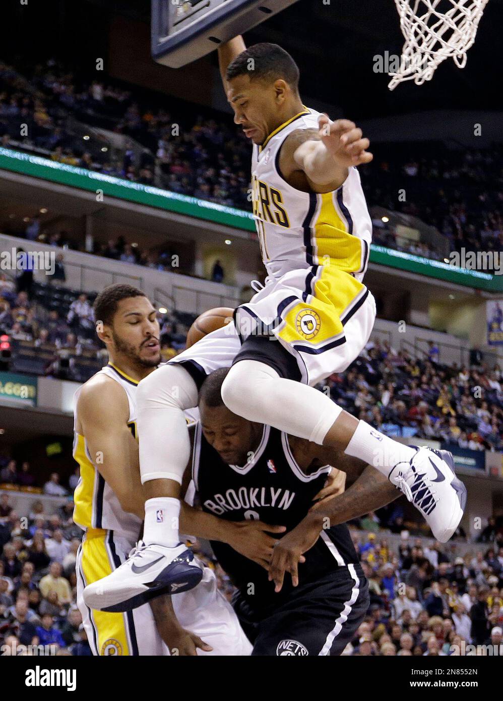 Indiana Pacers guard Orlando Johnson, top, comes down on the head of ...