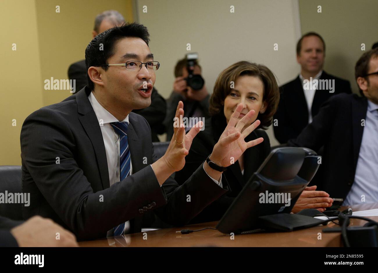 Economy Minister of Germany Philipp Roesler, left, speaks next to ...