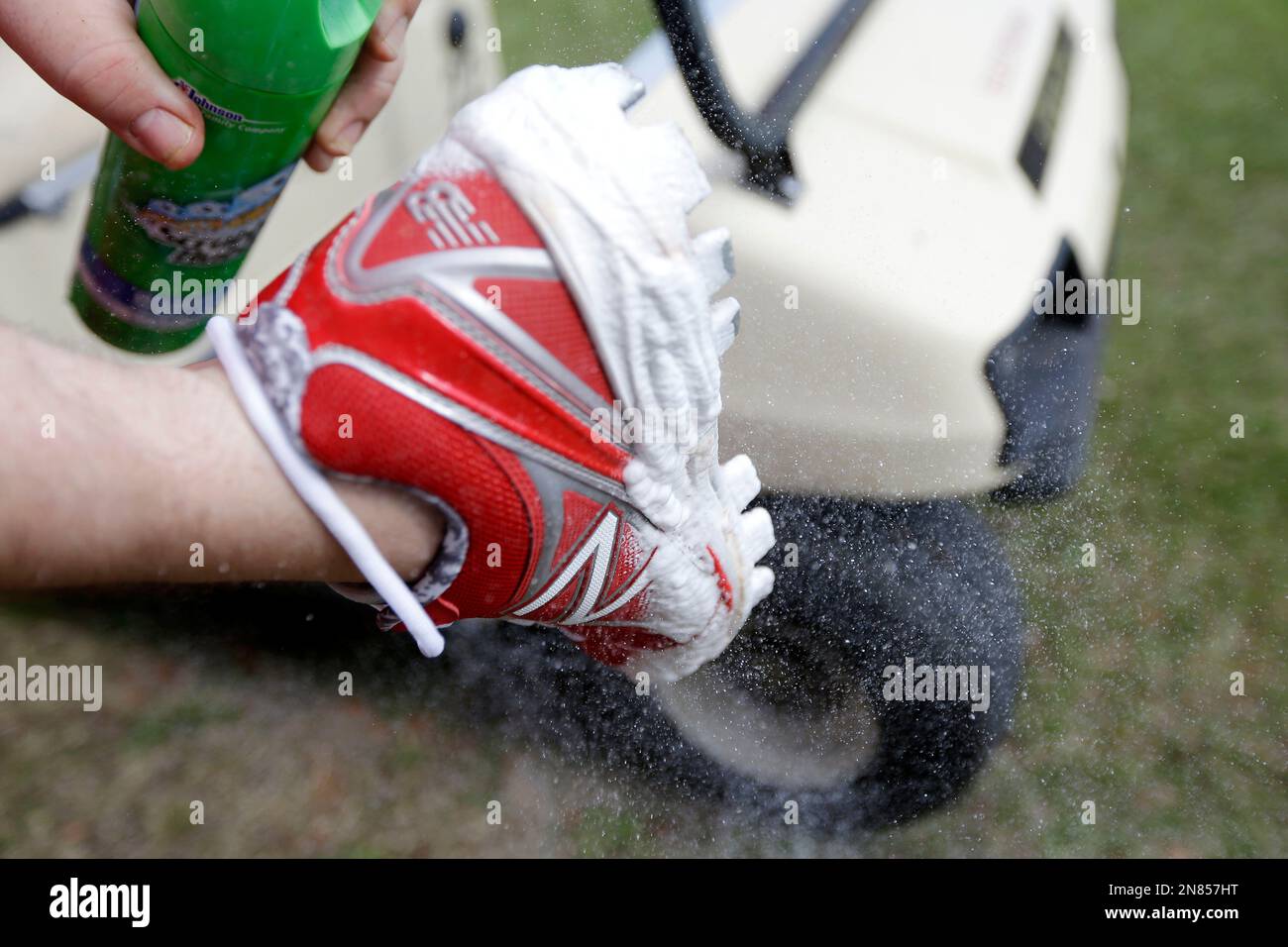 St. Louis Cardinals clubhouse worker Patrick Cramer cleans a cleat ...