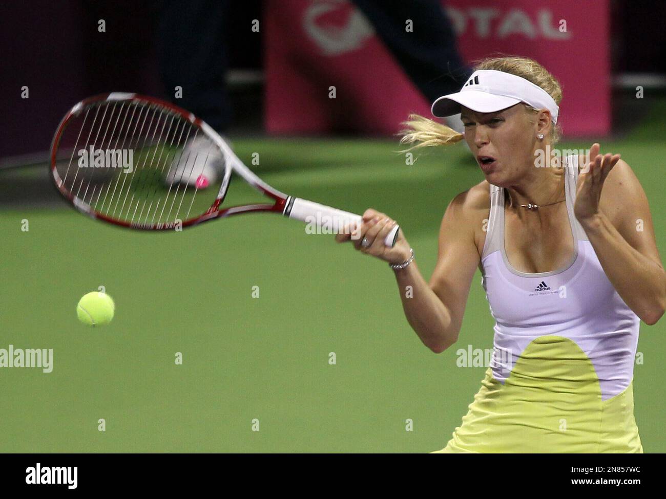 Caroline Wozniacki of Denmark returns the ball during her match against ...