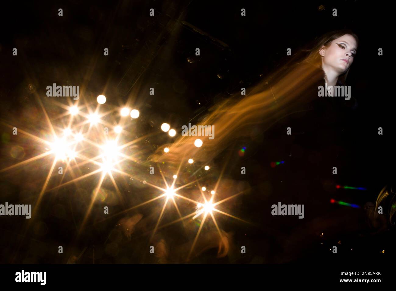 In this photo made with a long exposure and flash, a model practices ...