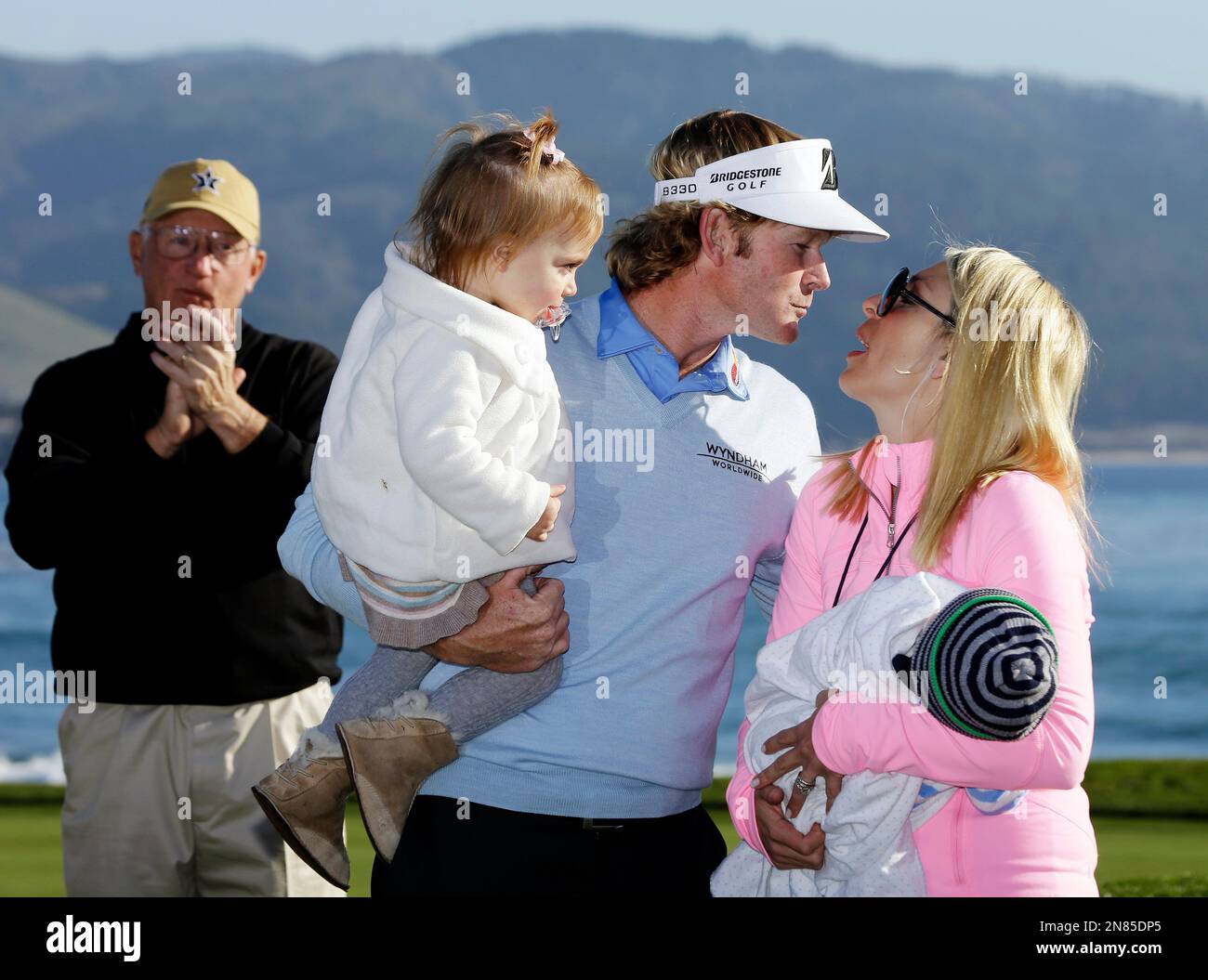 Brandt Snedeker, holding daughter Lilly, leans in to kiss his wife ...