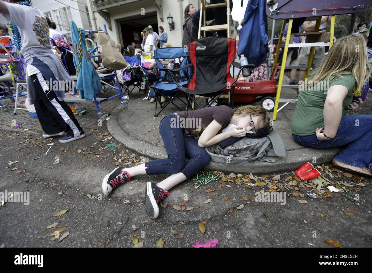 Victoria Mendel, 15, of New Orleans, rests between Mardi Gras parades ...