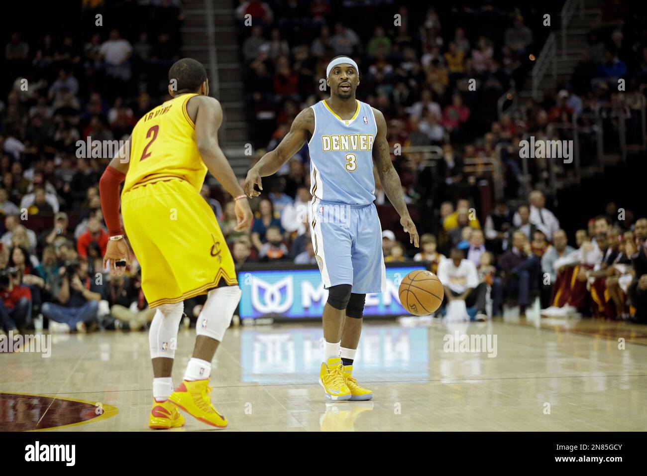 Denver Nuggets' Ty Lawson (3) calls a play against Kyrie Irving (2) and ...