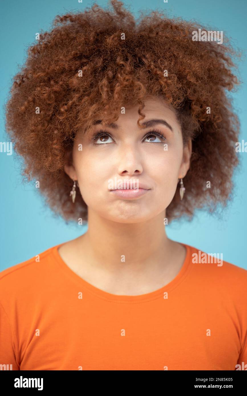 Comic, thinking and face of woman on blue background with ideas, vision ...