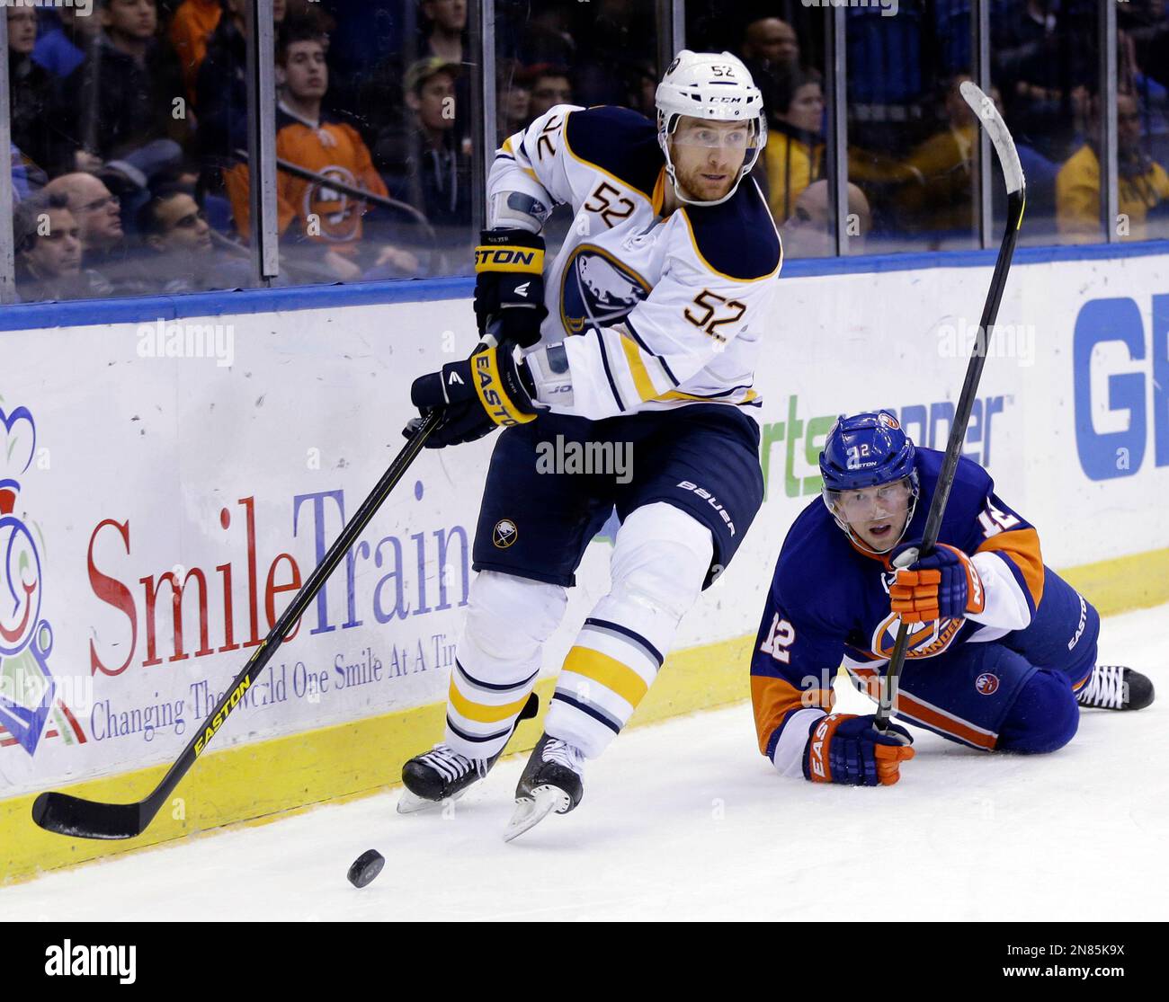 New York Islanders' Josh Bailey, right, falls while chasing Buffalo ...