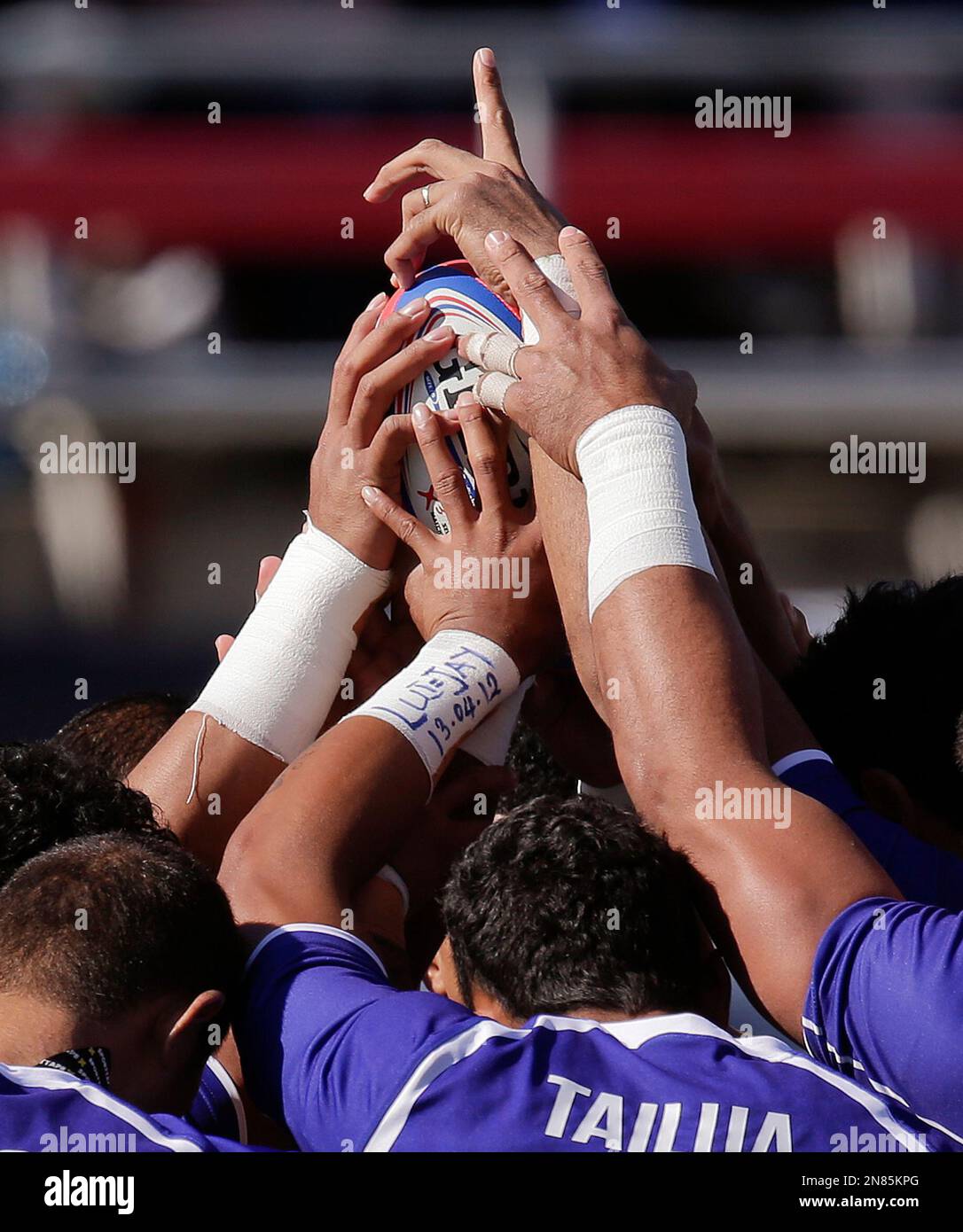 The Samoan sevens rugby team huddles at center field before playing ...