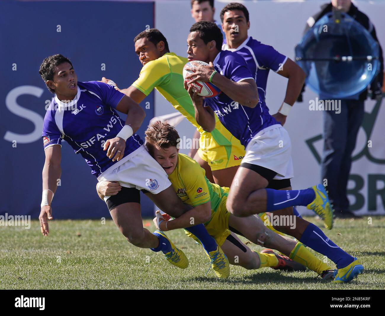 Samoa's Tulolo Tulolo, right, grabs a pass and runs it up field for a ...