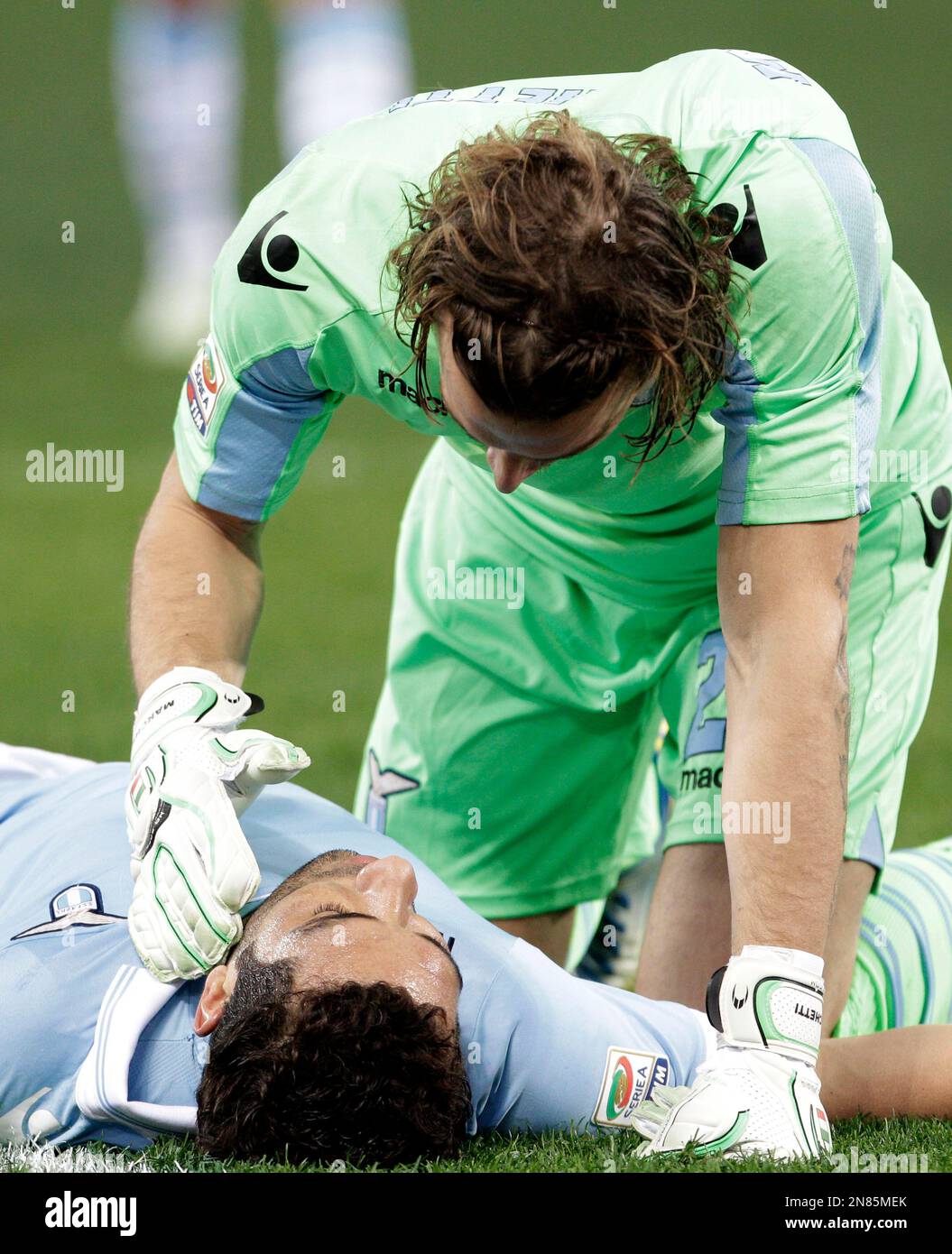 Lazio defender Andre Dias, of Brazil, bottom, is comforted by temmate ...