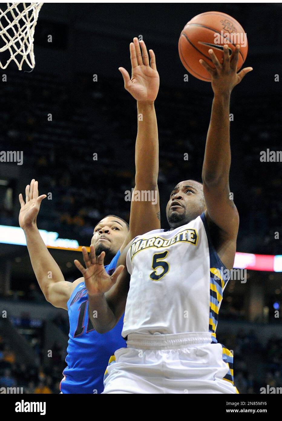 DePaul's Derrell Robertson Jr. defends as Marquette's Junior Cadougan ...