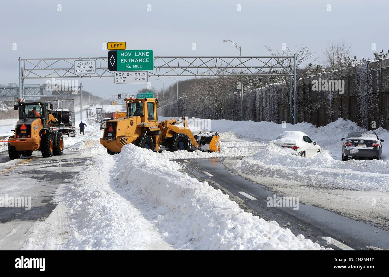 Payloaders clear snow from the Long Island Expressway just west of exit ...