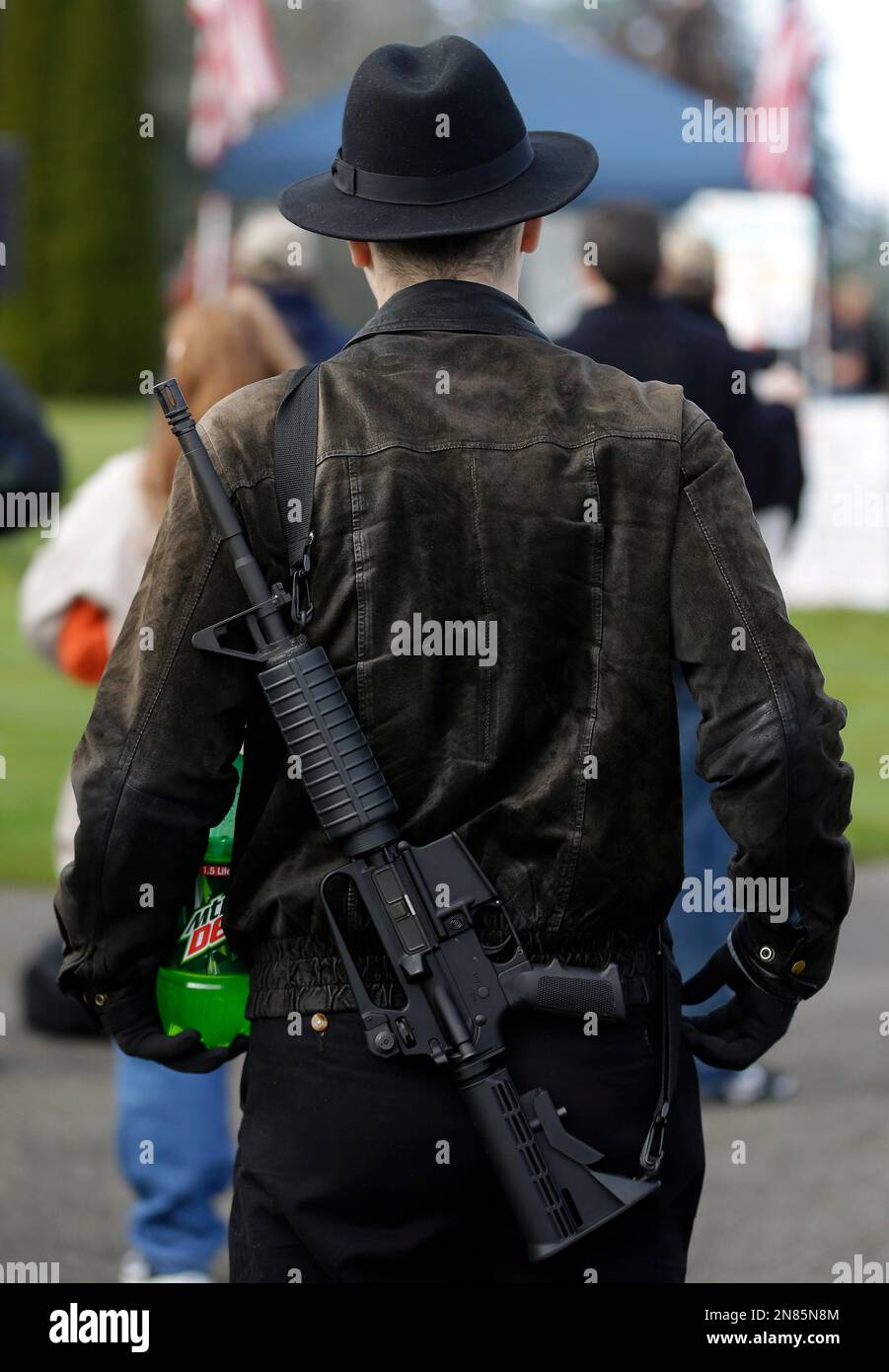 Kevin Vangelder wears his AR-15 rifle as he attends a gun rights rally ...