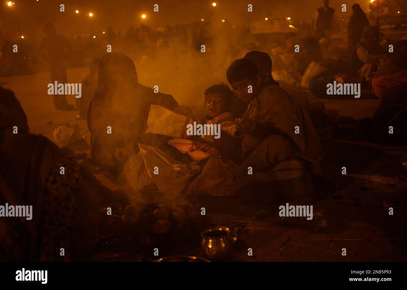 A Hindu devotee family has dinner as they settle down for the night at ...